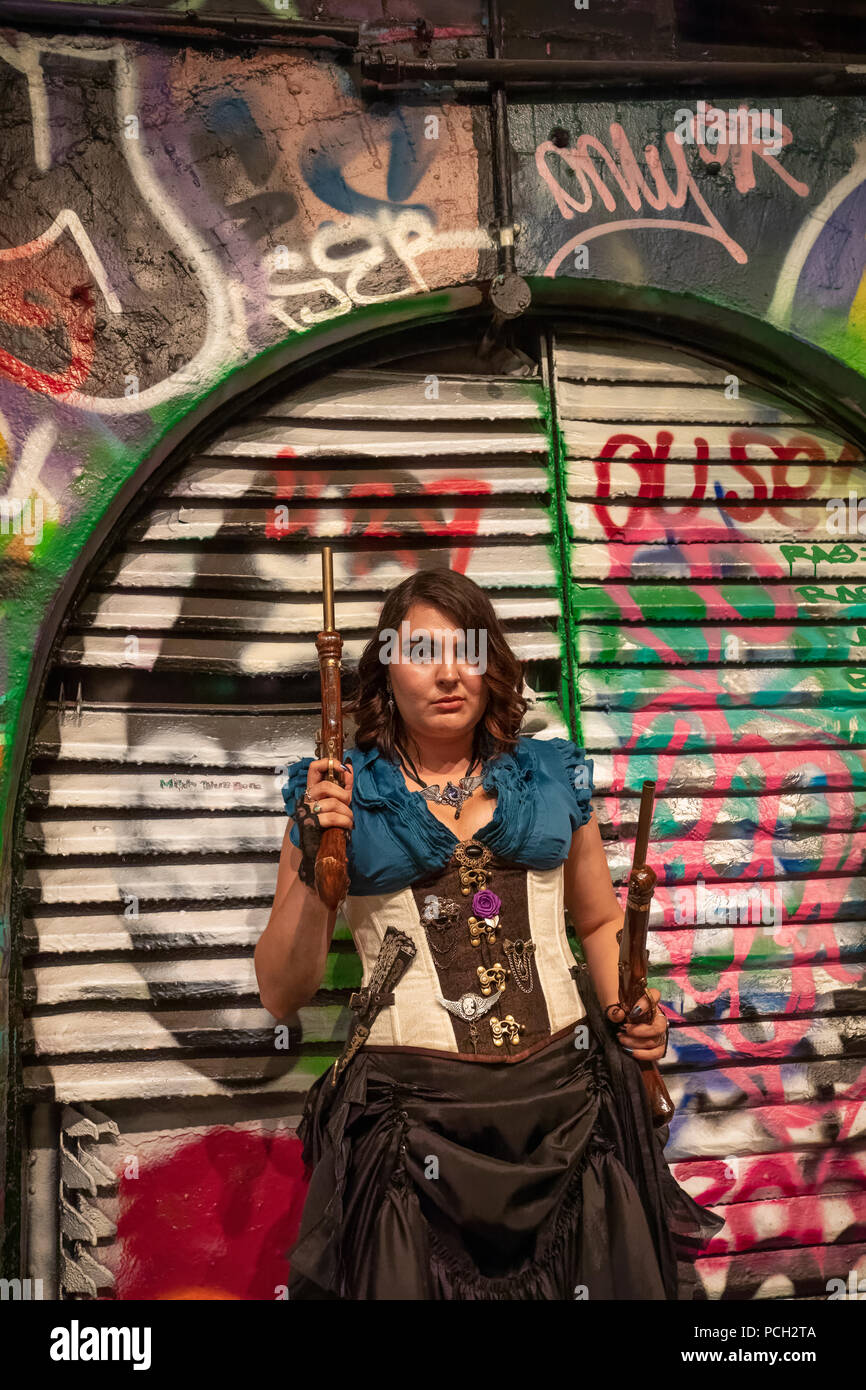 Woman in front of graffiti on London wall Stock Photo - Alamy