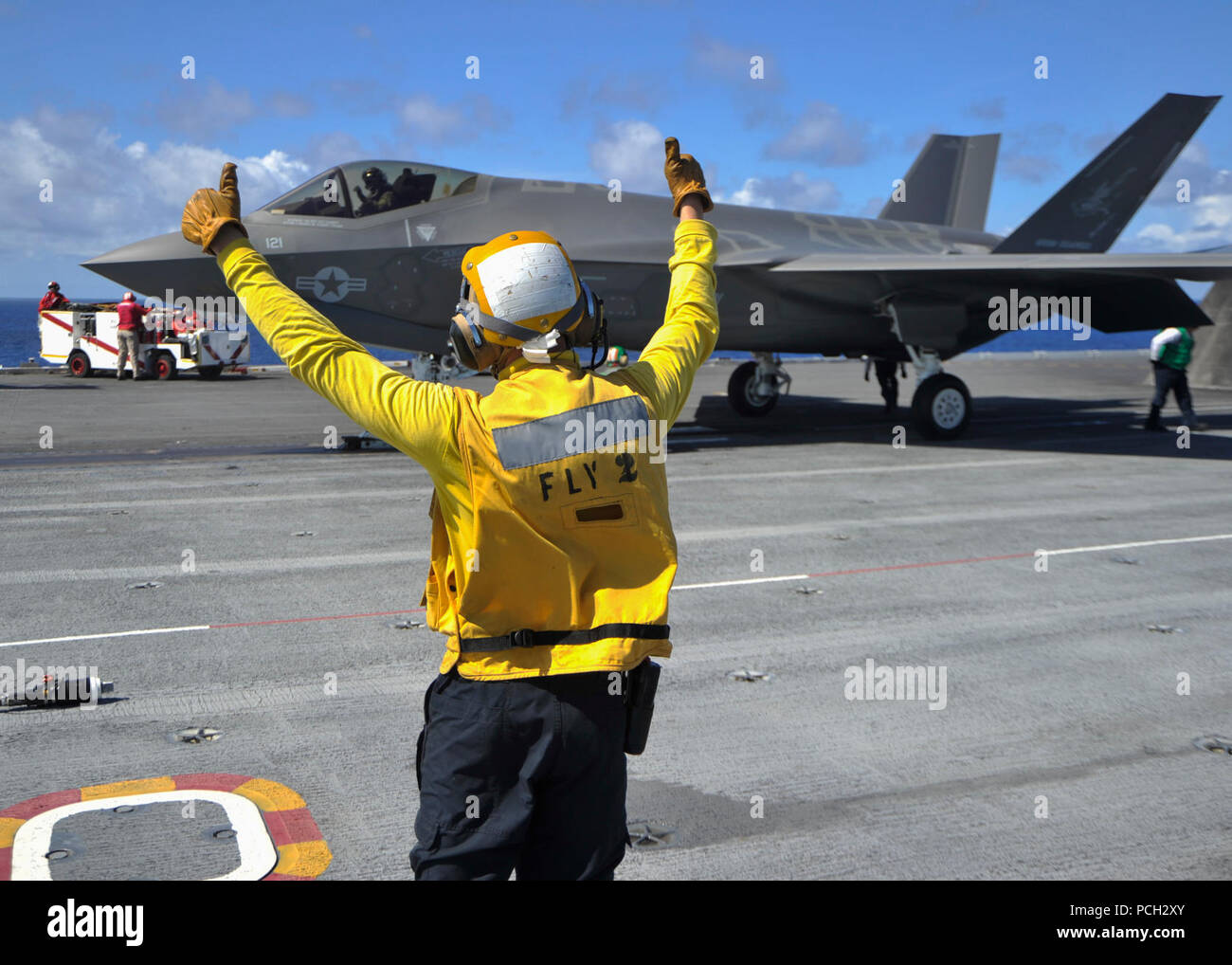 ATLANTIC OCEAN (Aug. 14, 2016) A Sailor communicates with the pilot of ...