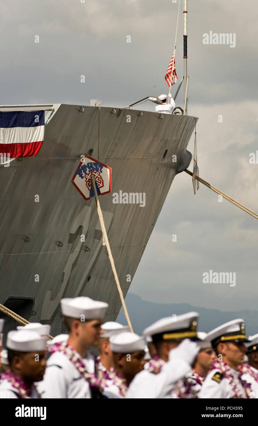 PEARL HARBOR (Oct. 26, 2012) A Sailor lowers the flag during a ...
