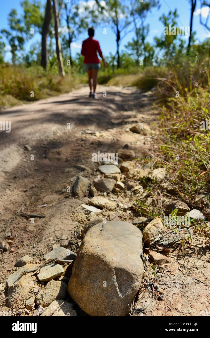 A woman walks down a dry dusty road through a hi-res stock photography ... A woman walks down a dry dusty road through a hi-res stock photography ...