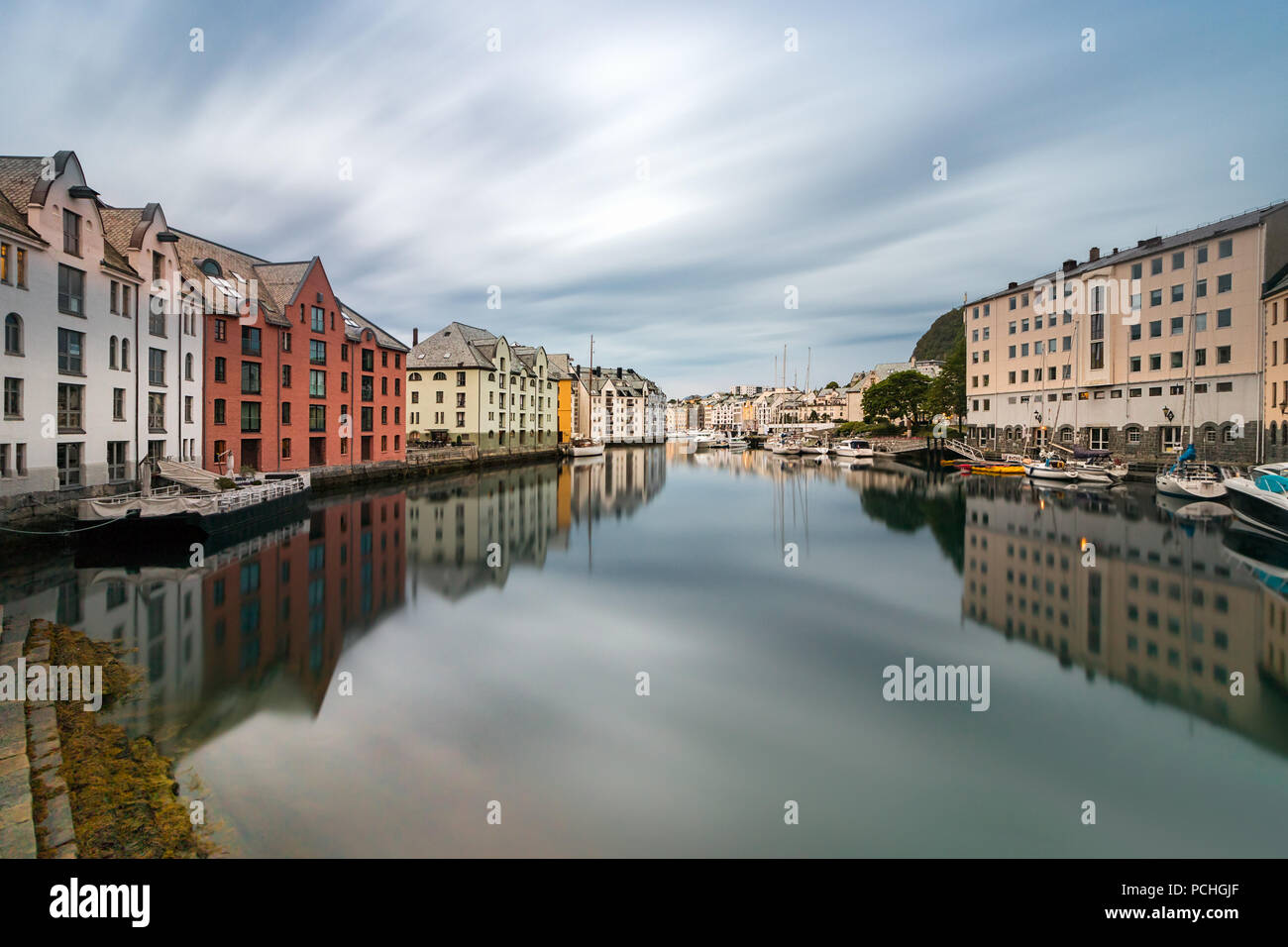 View of the Art Nouveau buildings reflected in the water at sunrise in ...