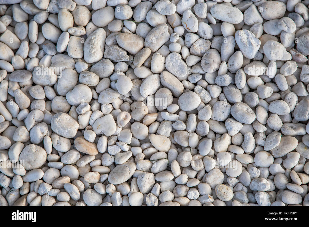 Pile of white pebble stones for background Stock Photo - Alamy