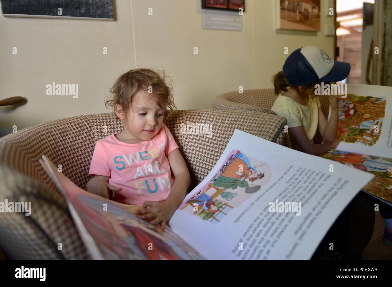 Two children reading books at the Herveys Range Heritage Tea Rooms ...