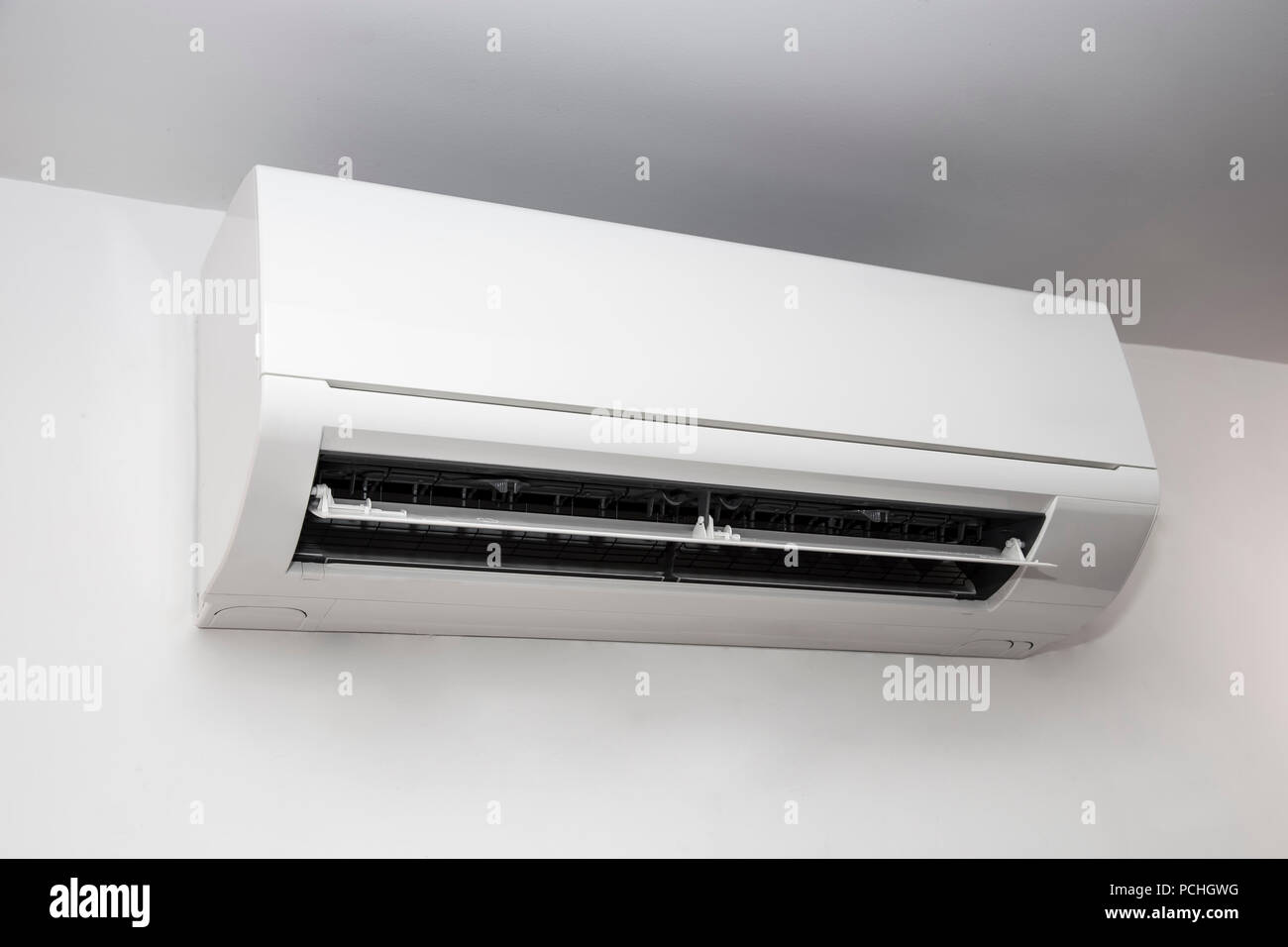 Air conditioner machine on white wall background Stock Photo - Alamy