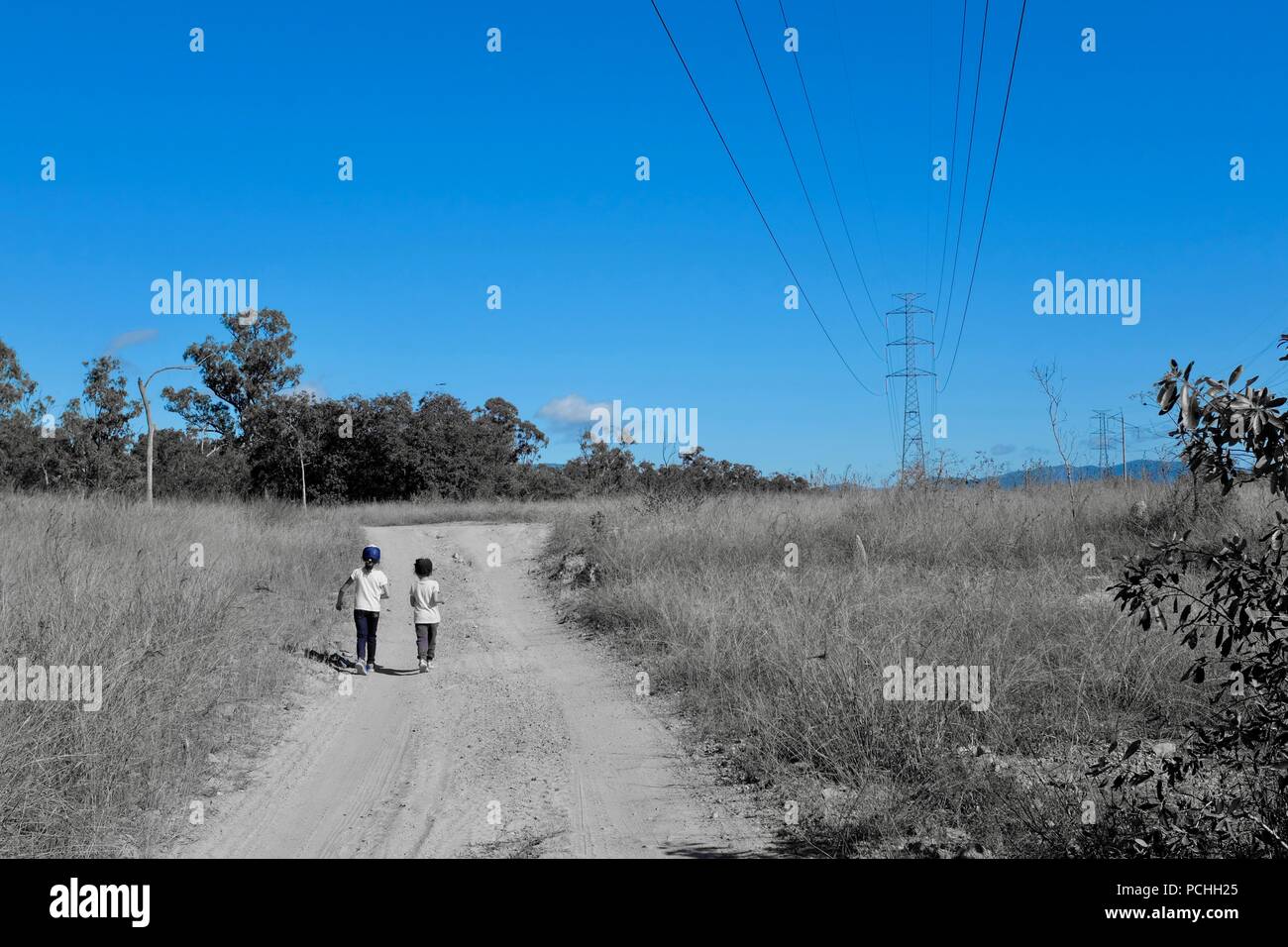 Two children walk along a dry dusty road black hi-res stock photography ... Two children walk along a dry dusty road black hi-res stock photography ...