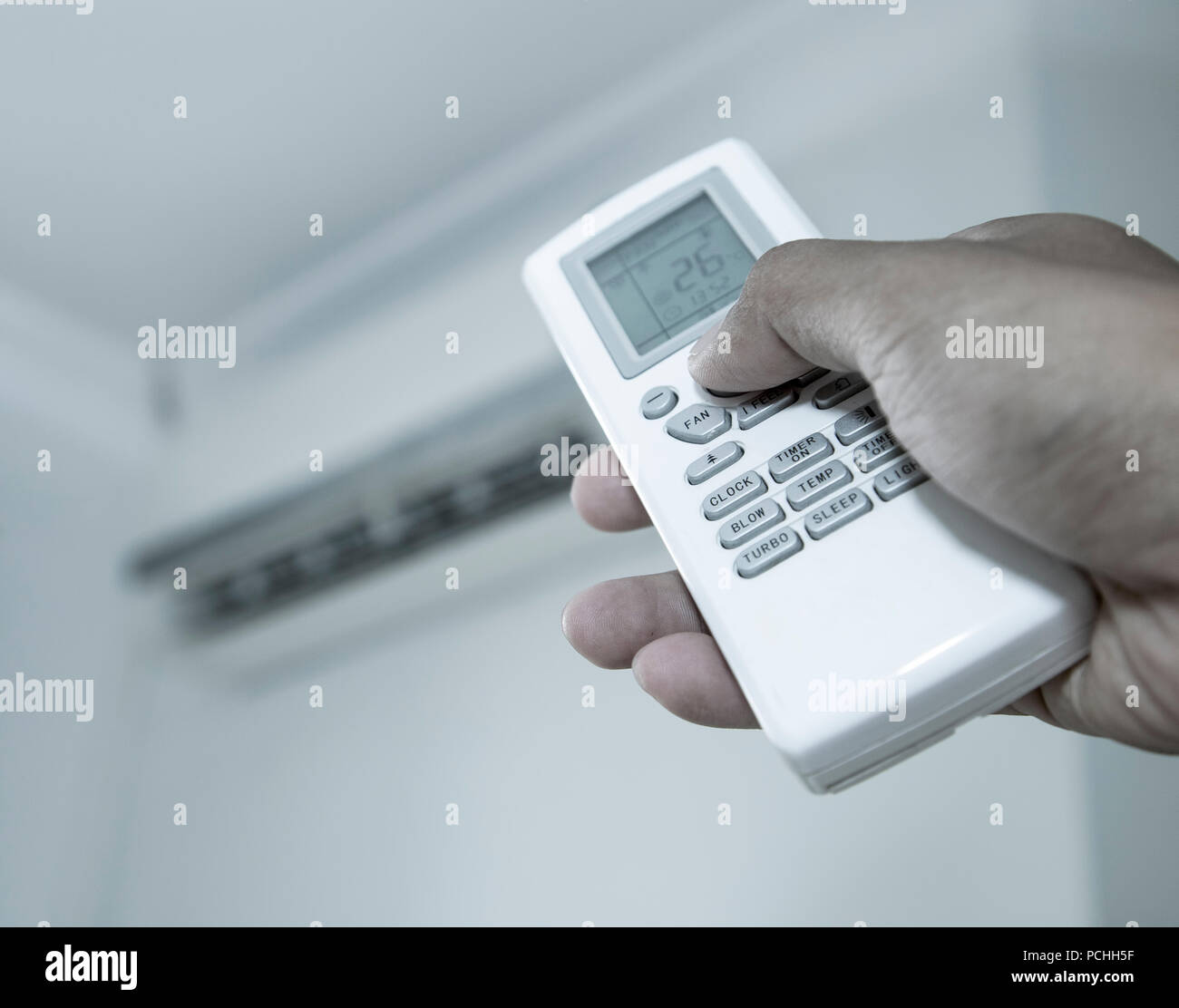 Hand press the button on the remote of the air conditioner Stock Photo ...