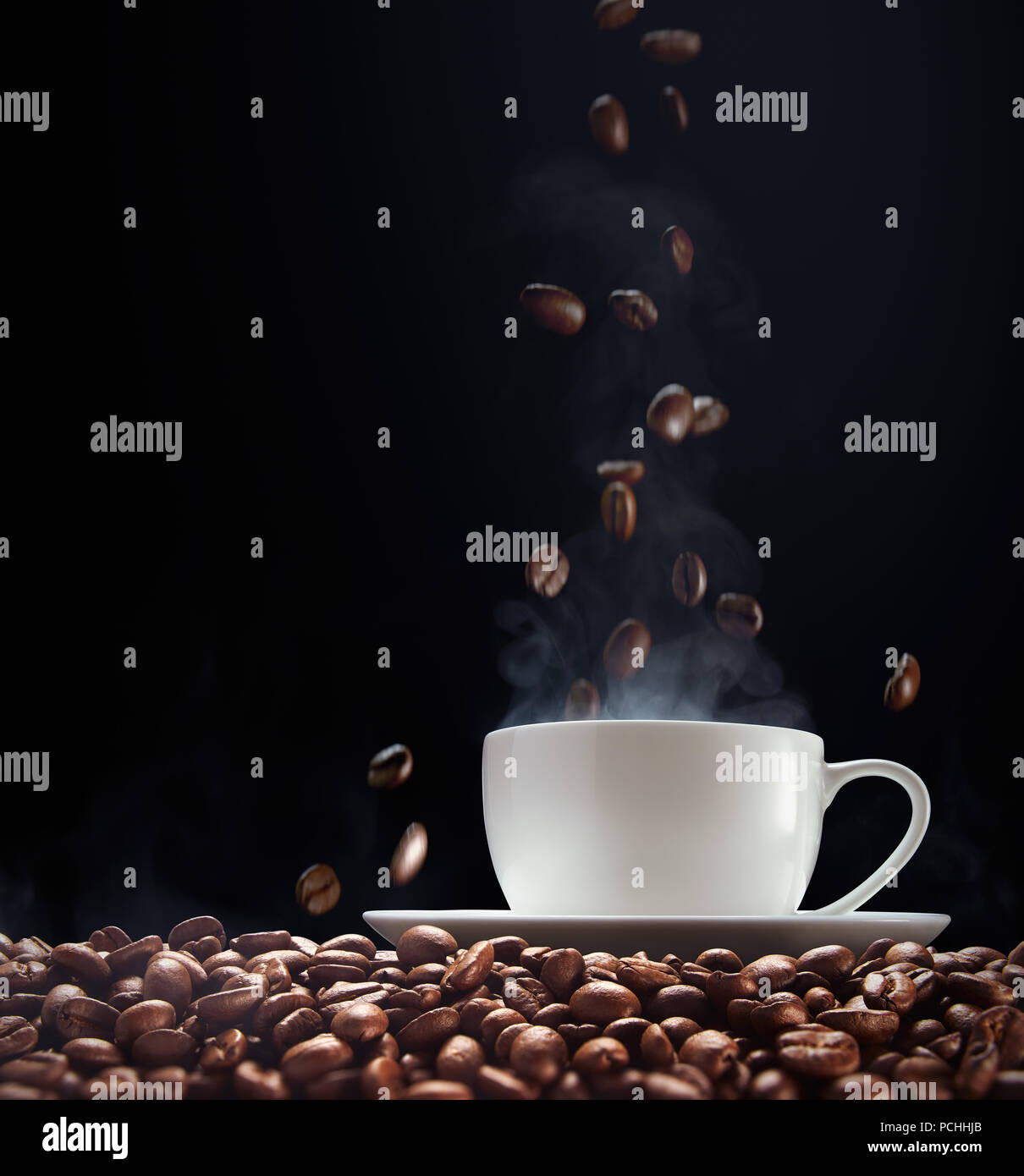 Coffee beans dropping into a cup of coffee Stock Photo - Alamy