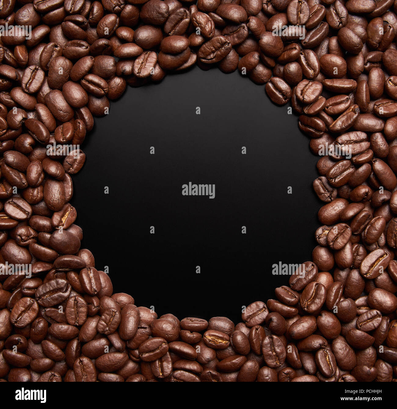 Coffee beans forming a circle over dark background Stock Photo - Alamy