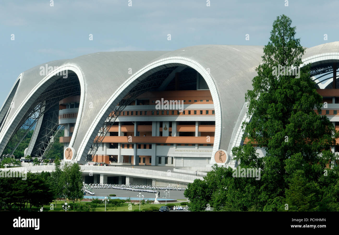 Many students in white shirts under the arches of the May day stadium ...