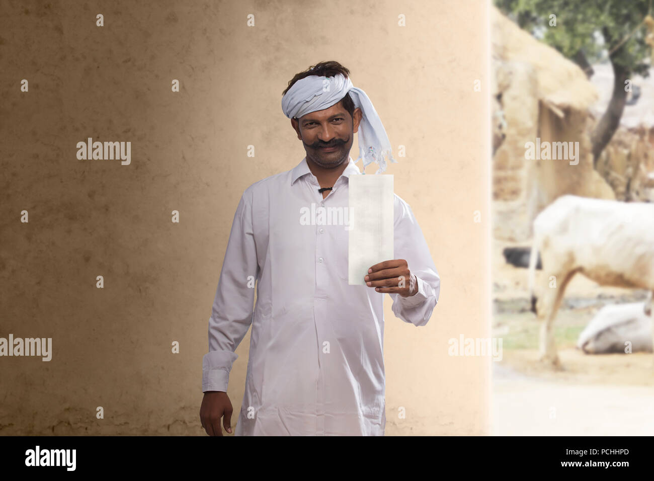 Portrait of a rural man showing a bank cheque Stock Photo - Alamy