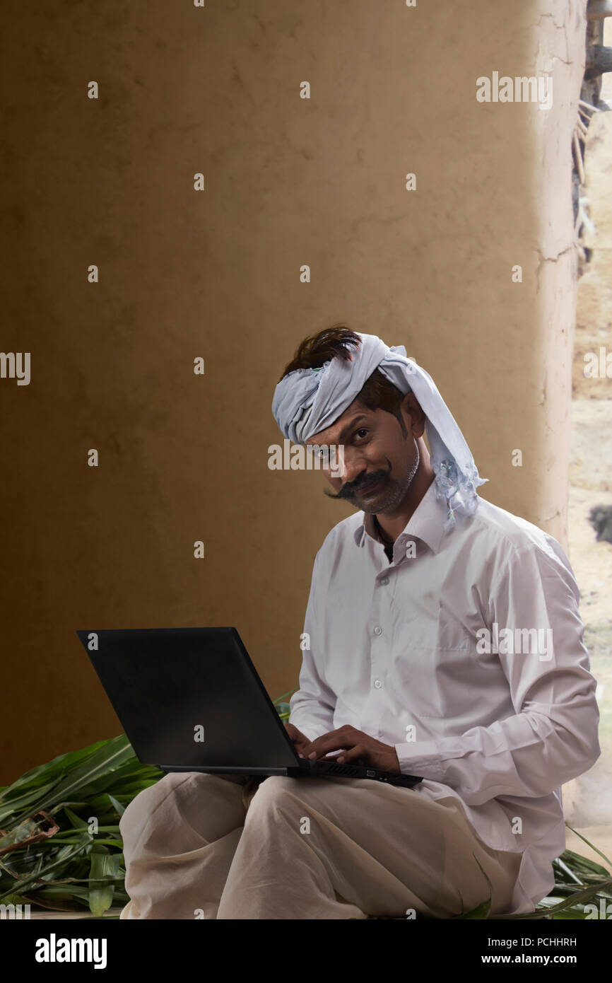 Rural man using laptop Stock Photo - Alamy