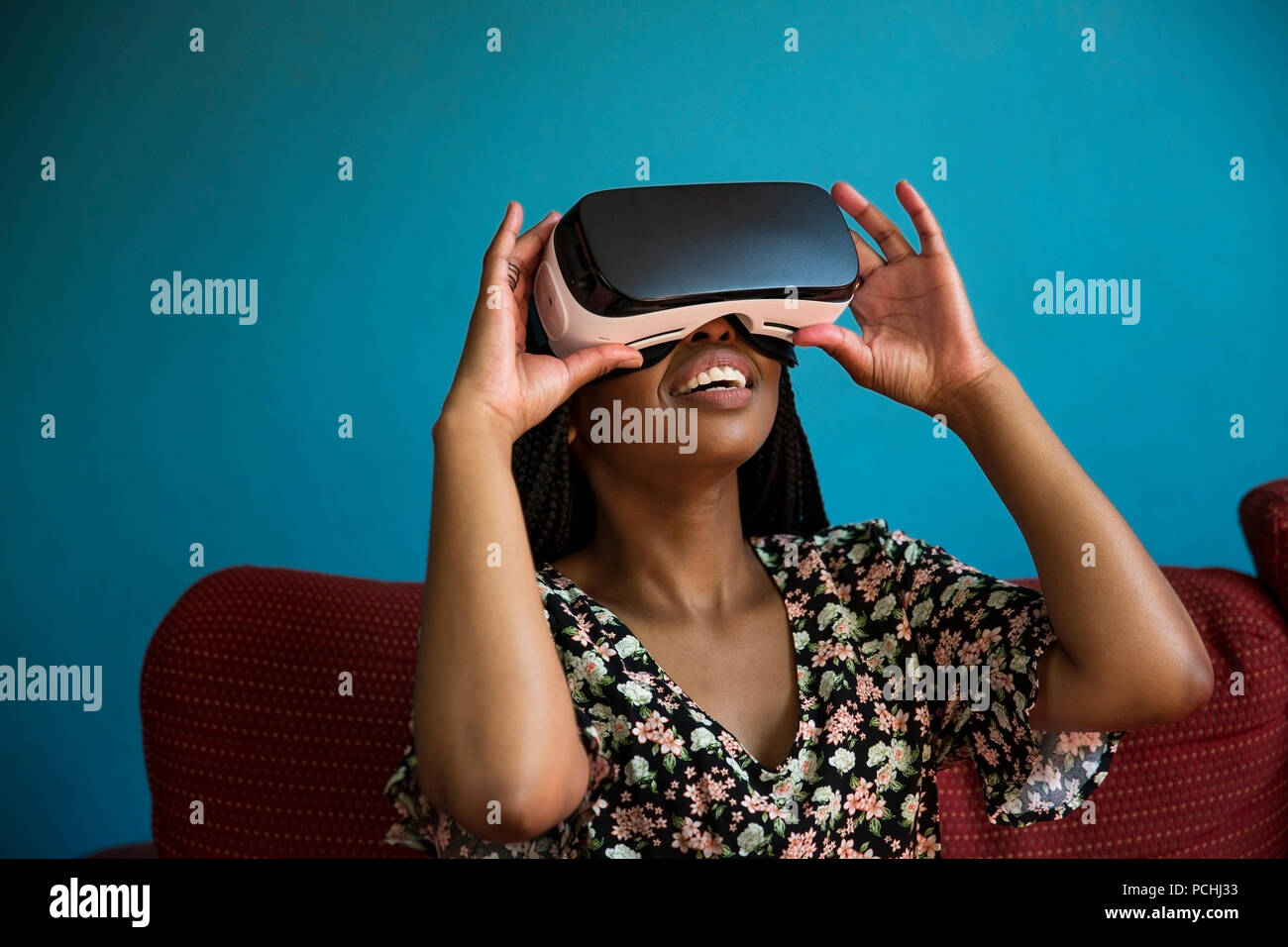 African woman looking through VR headset Stock Photo - Alamy