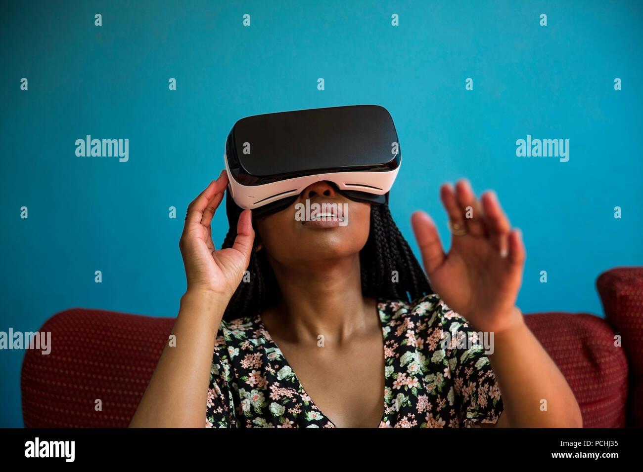 African woman looking through VR headset Stock Photo - Alamy