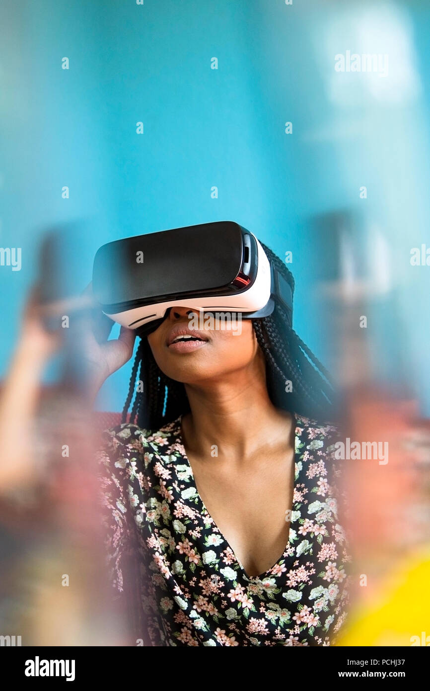 African woman looking through VR headset Stock Photo - Alamy