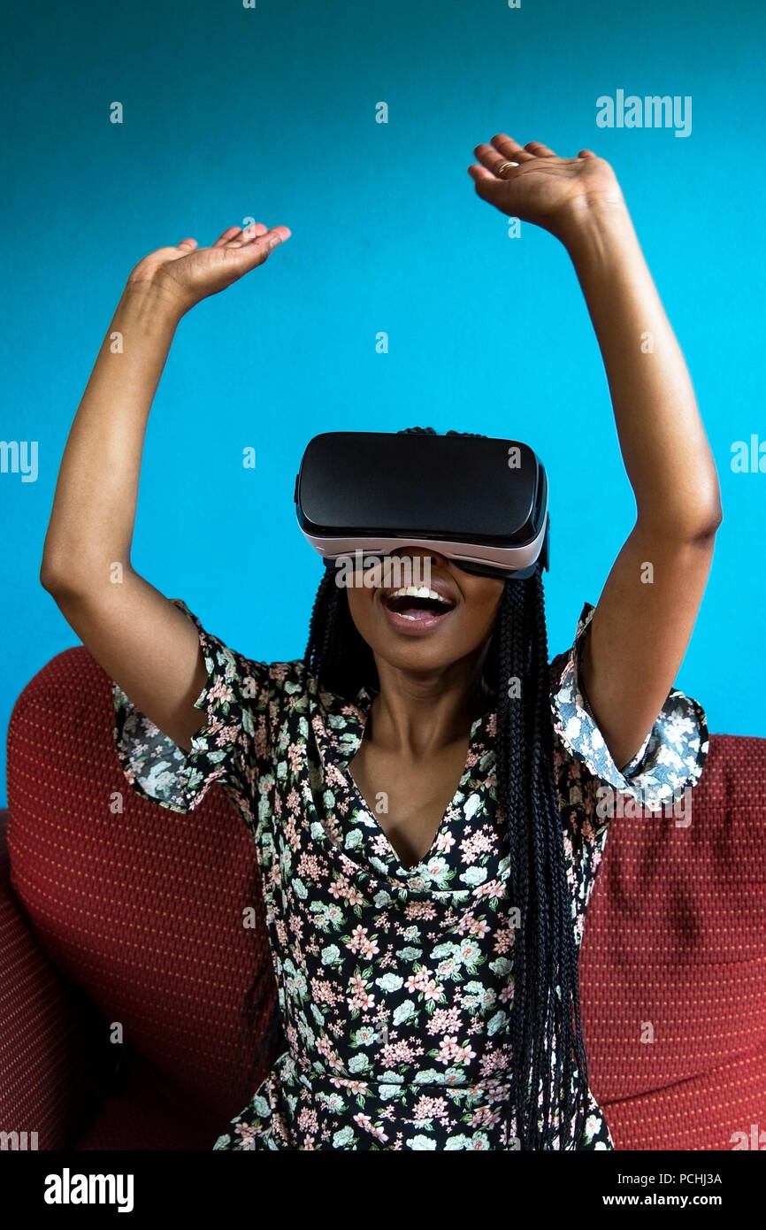 African woman looking through VR headset Stock Photo - Alamy
