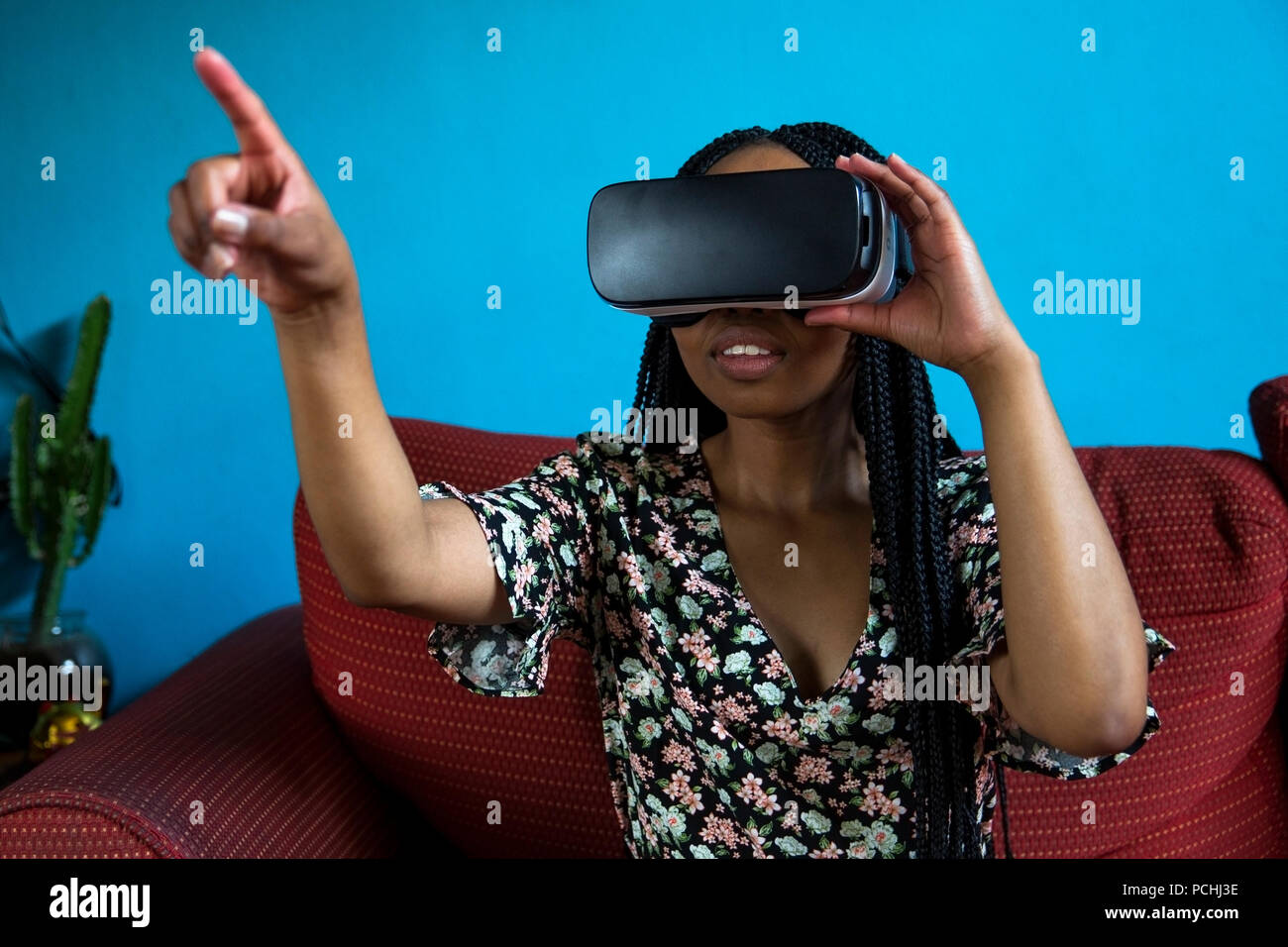 African woman looking through VR headset Stock Photo - Alamy