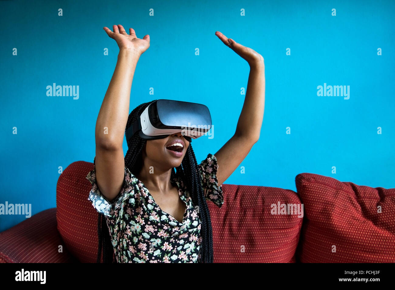 African woman looking through VR headset Stock Photo - Alamy