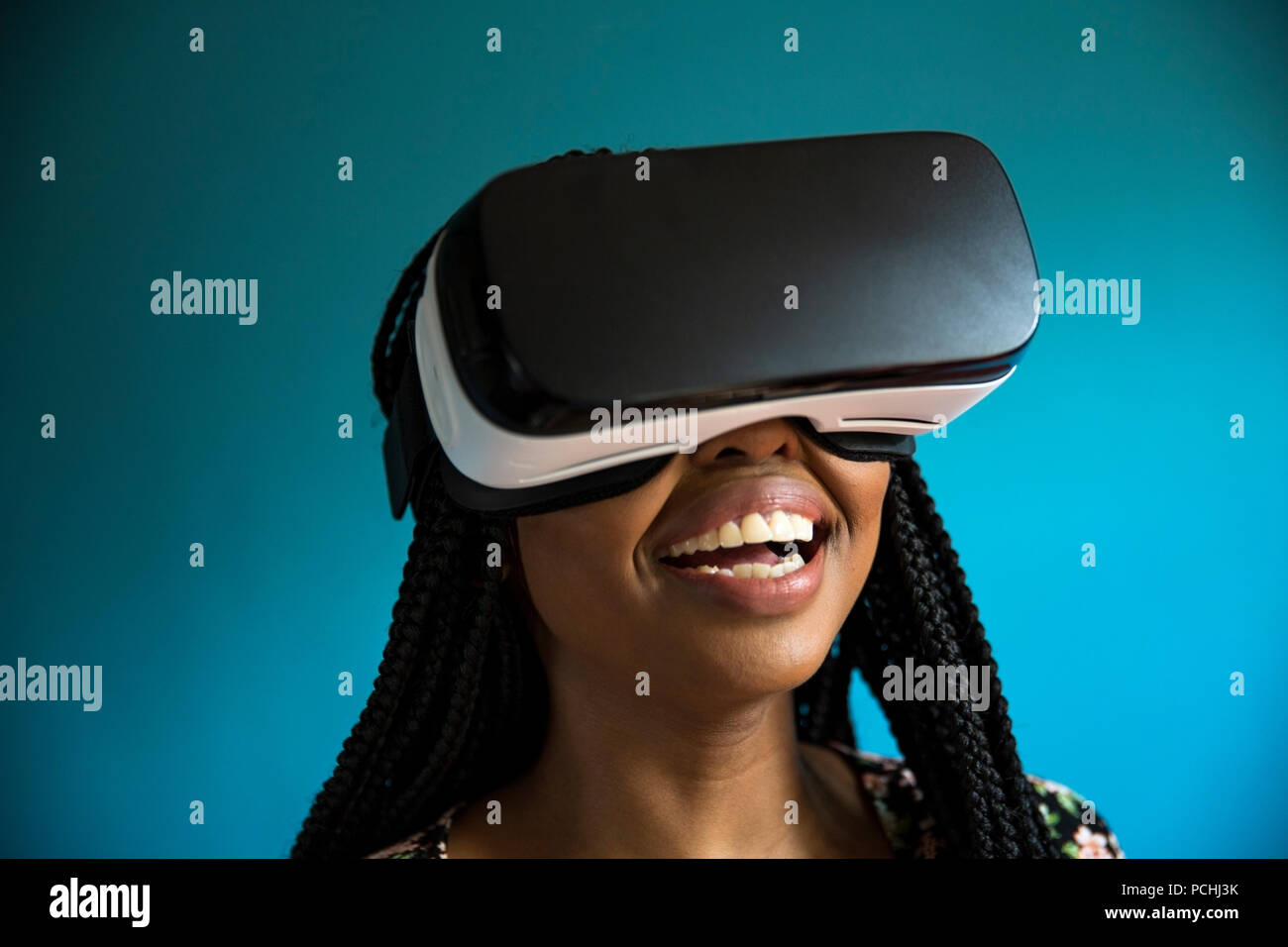 African woman looking through VR headset Stock Photo - Alamy
