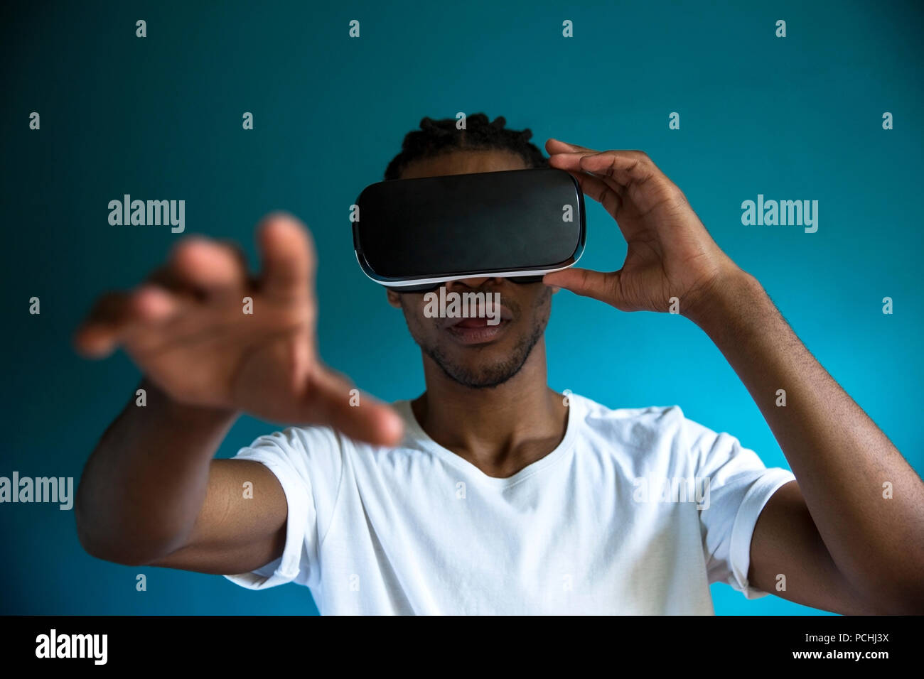 African man looking through VR headset Stock Photo - Alamy