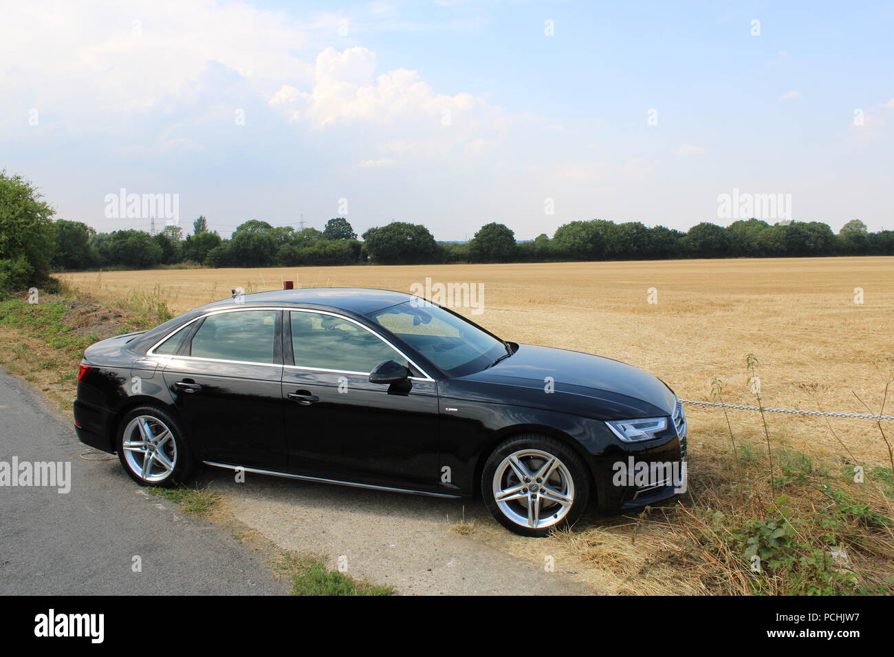 Black Audi Saloon car parked on country road Stock Photo - Alamy
