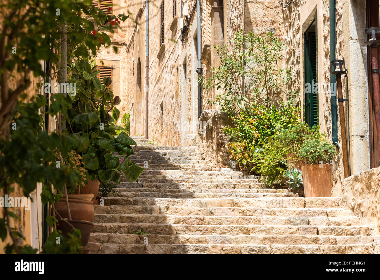 Mediterranean alleyway in Mallorca Spain with stairs in an ancient and ...