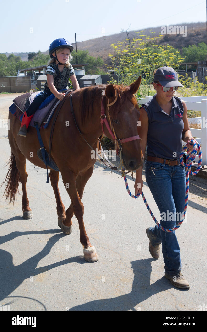 Tanaya Wilson (right), an employee for Stepp Stables, teaches ...