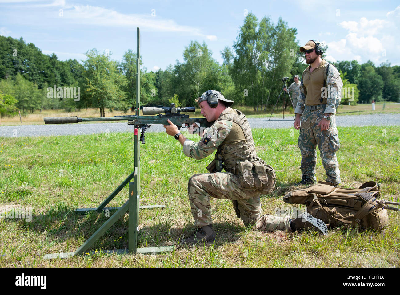 Sniper from the United Kingdom prepare to fire from the kneeling ...
