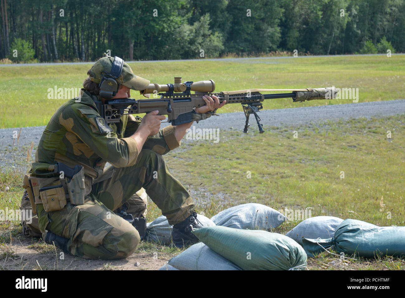 A Norwegian soldier engages targets during the precision marksmanship ...
