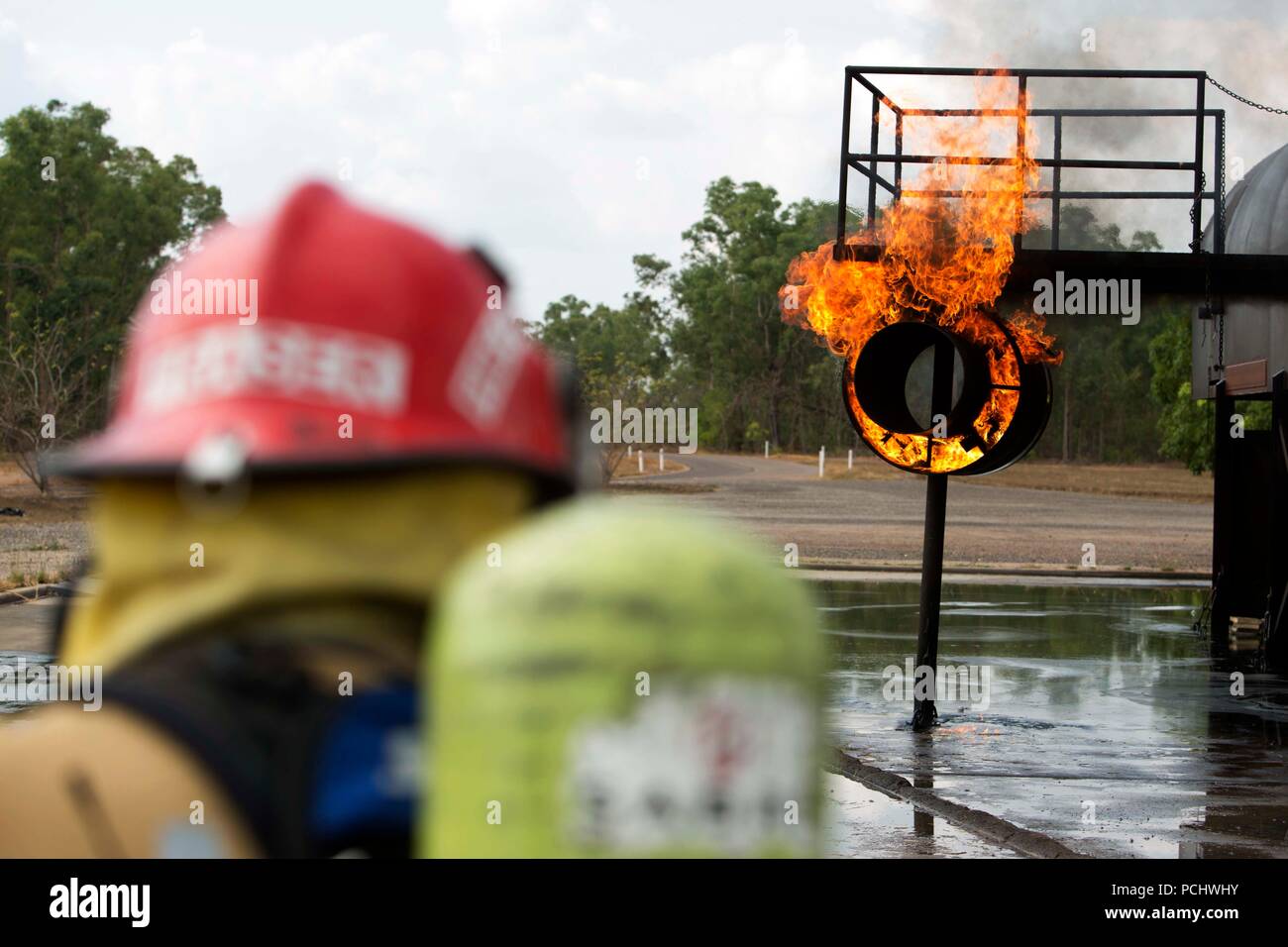 An Australian firefighter observes a fire during a joint live fuel fire ...