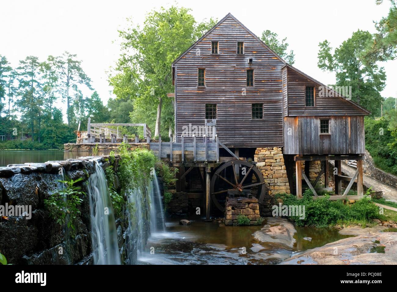 Waterfall and old gristmill at Historic Yates Mill County Park in ...