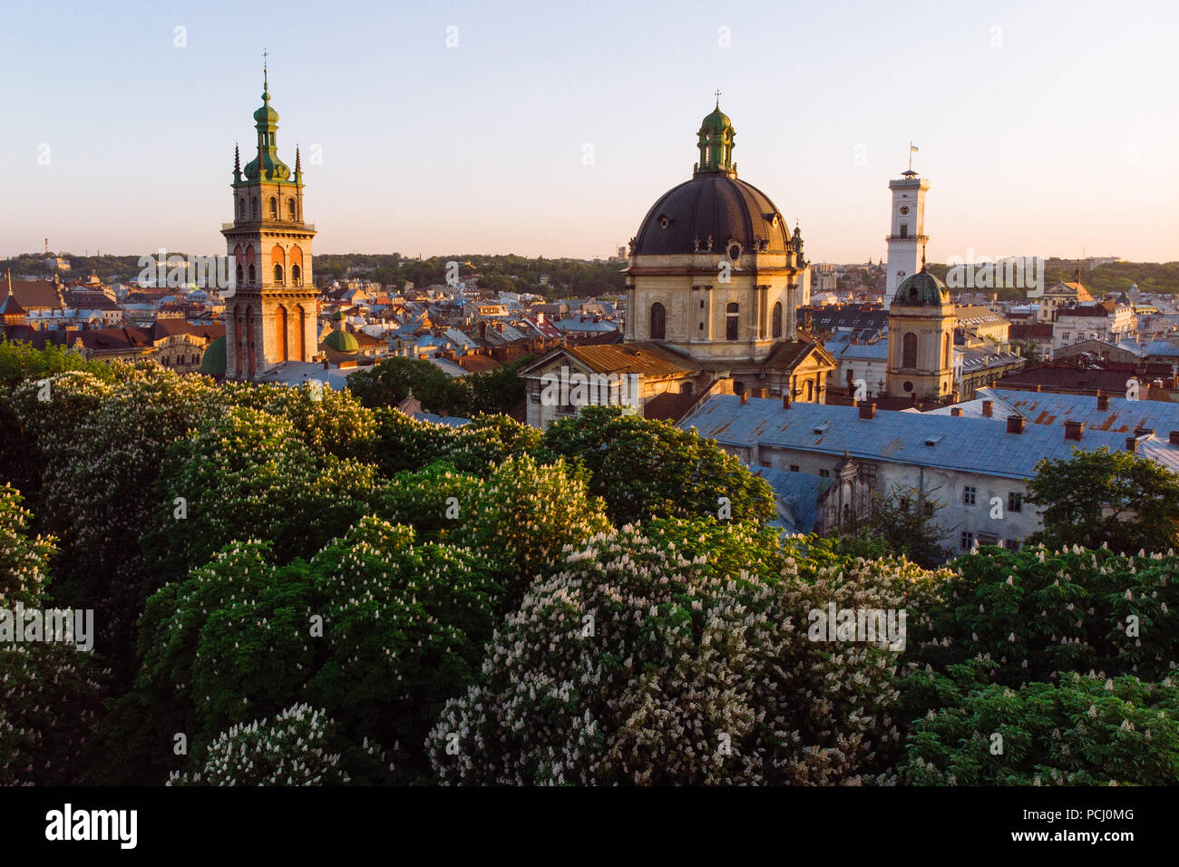 aerial view of old european city on sunset. blooming trees Stock Photo ...
