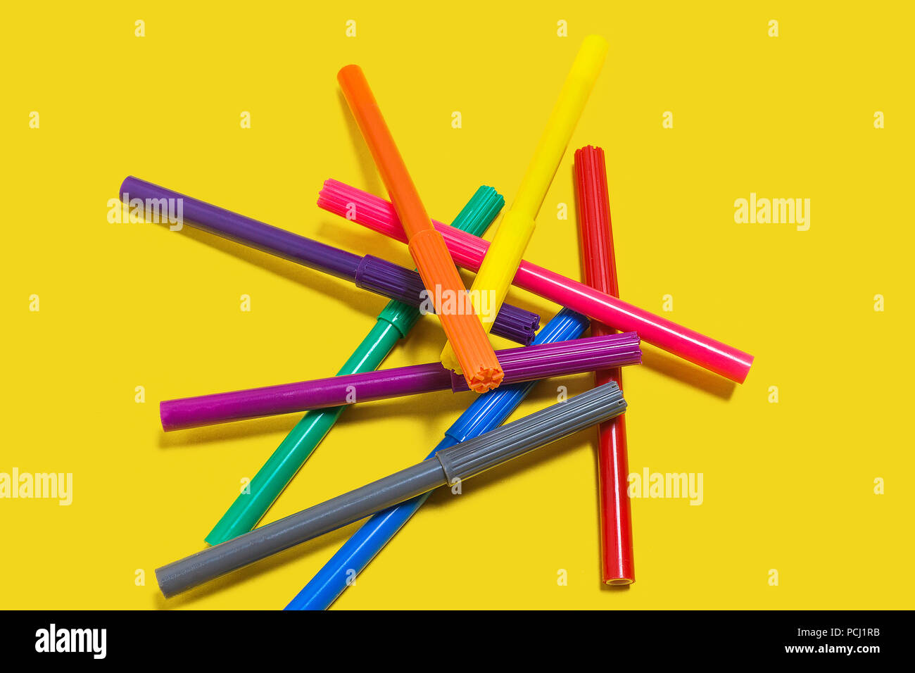 collection of felt pens on a yellow background Stock Photo - Alamy
