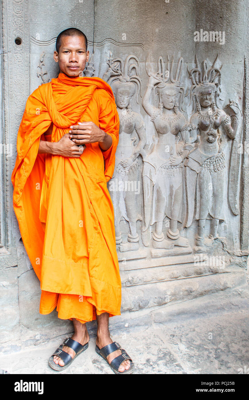 Angkor Wat, Cambodia - 11th January 2018: Monk stood by a bas relief ...