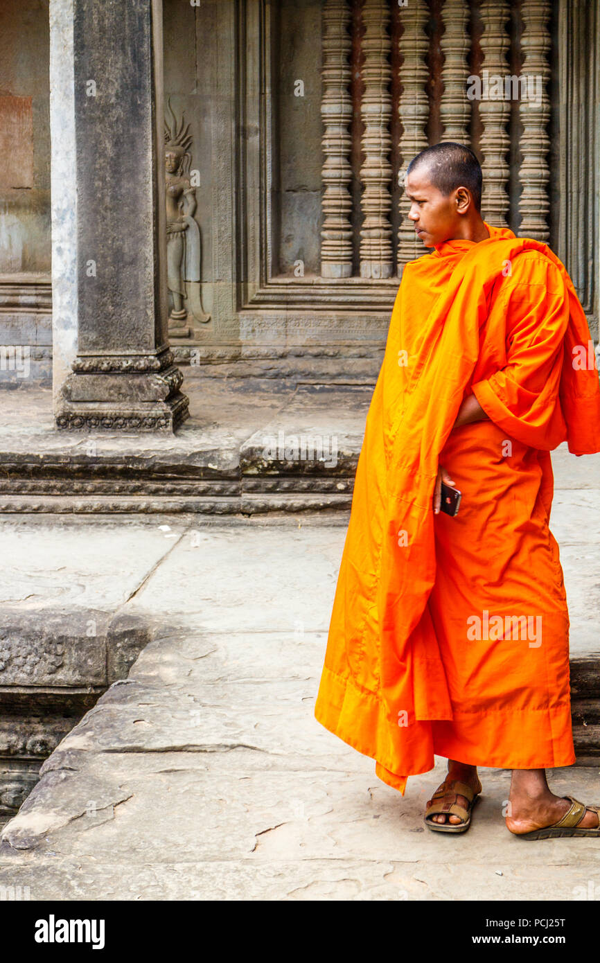 Angkor Wat, Cambodia - 11th January 2018: Monk stood by a bas relief ...