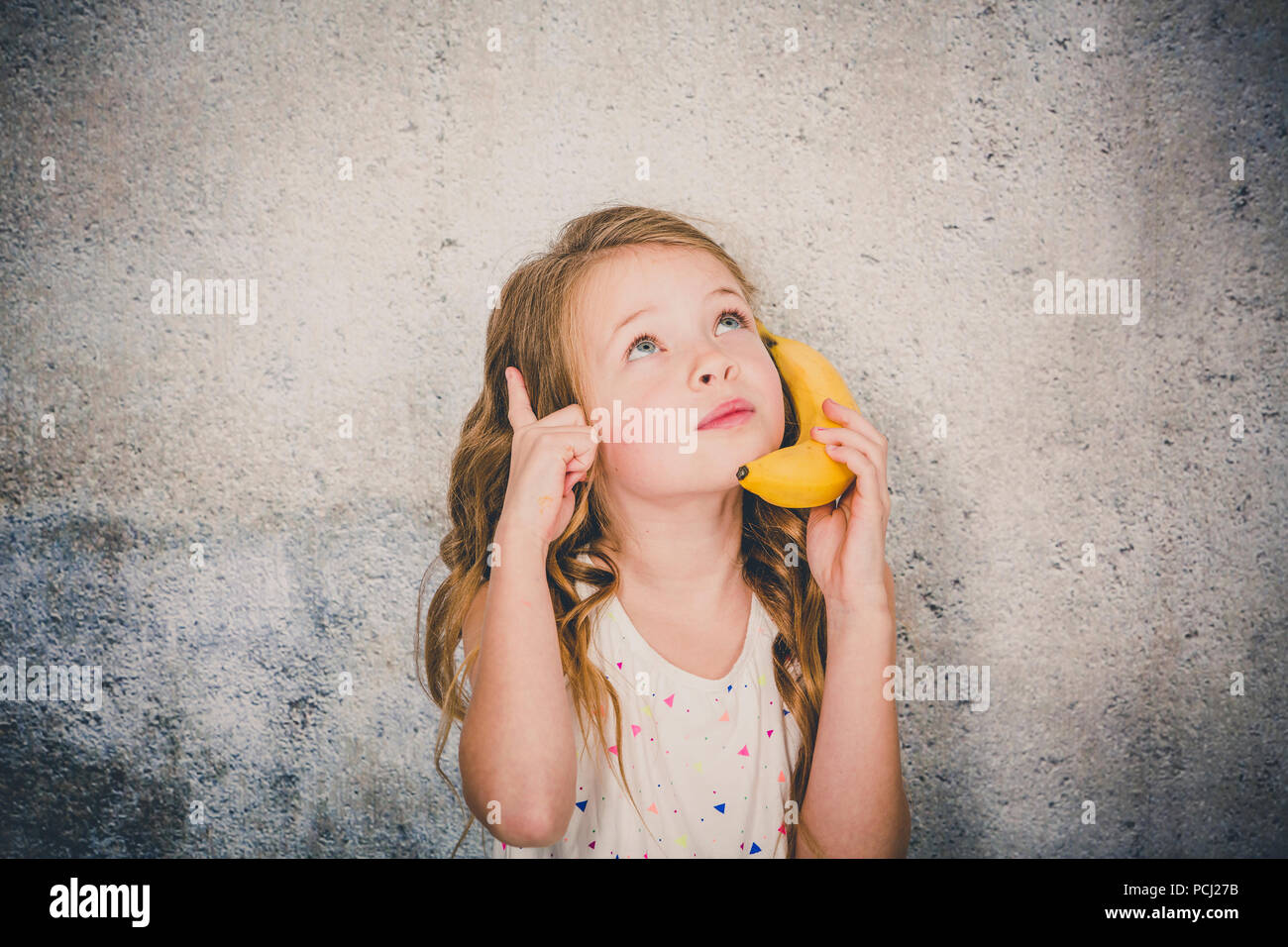 blond, Pretty girl is doing phone call with a banana Stock Photo - Alamy