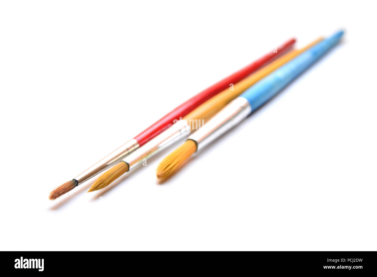 three paint brushes isolated on white Stock Photo - Alamy