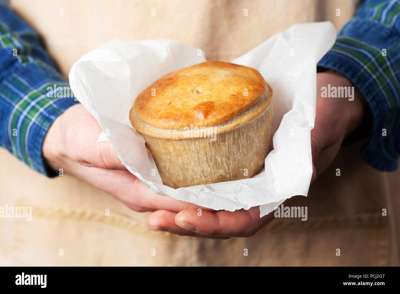 A Baker holds a meat pie in his two hands Stock Photo - Alamy