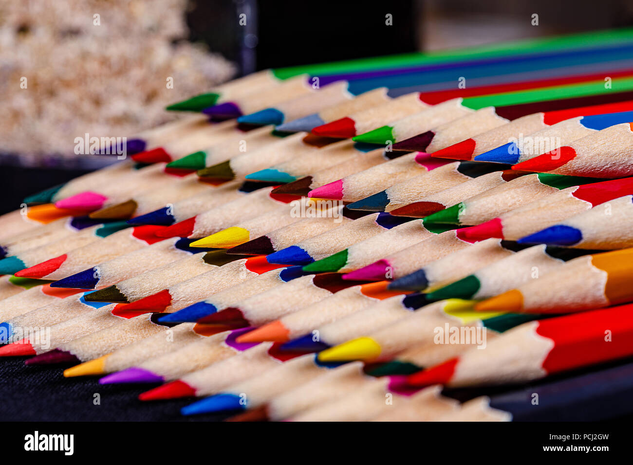 Colored Pencils stacked neatly in a random color pattern but in a very ...