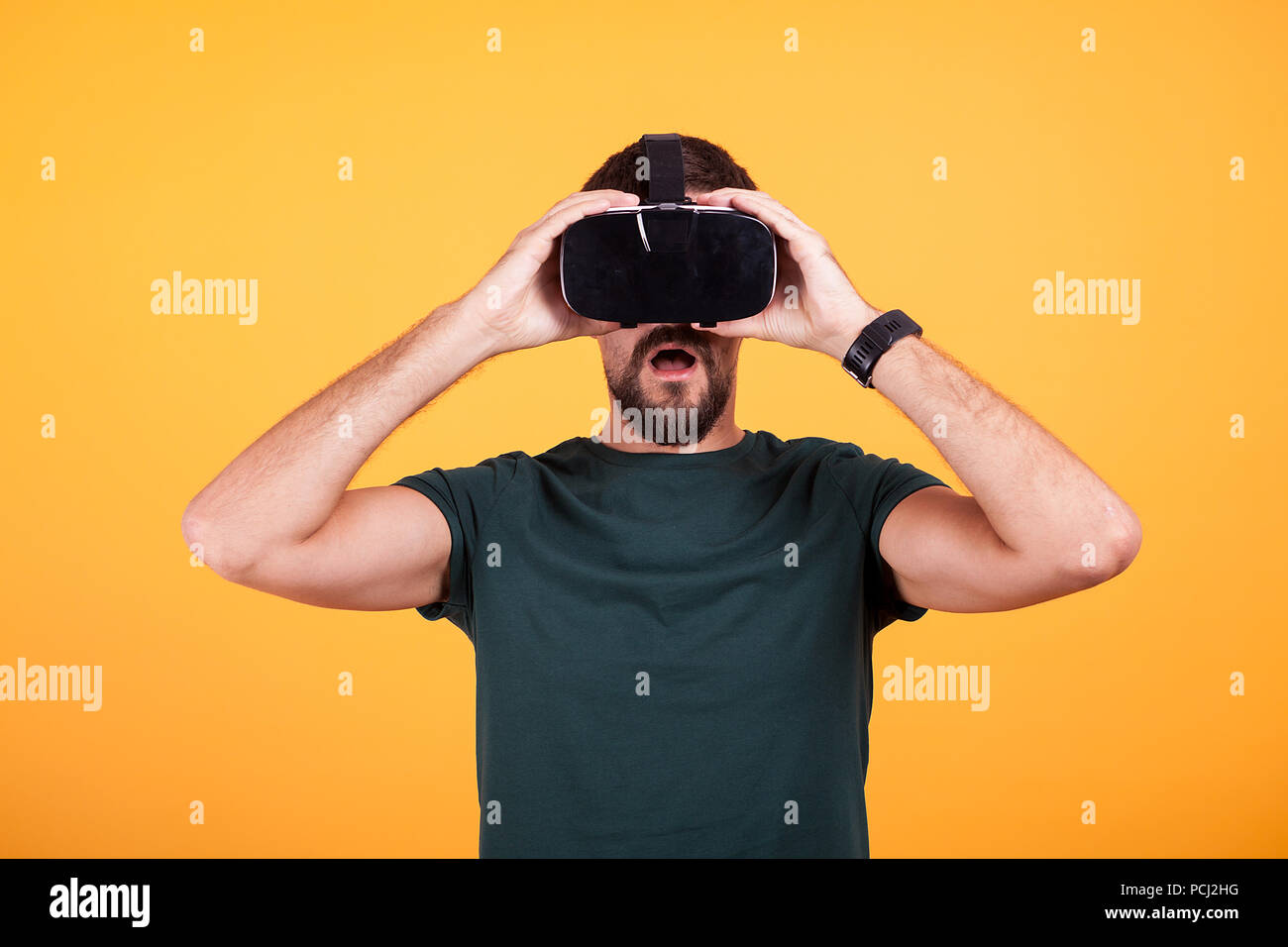 VR virtual reality headset on amazed man head who is trying it for the ...