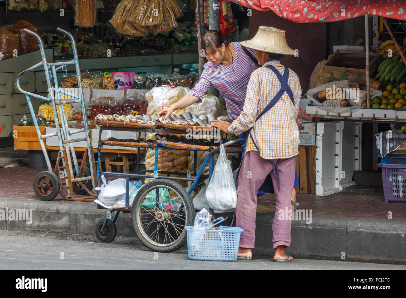 Bangkok, Thailand - 28th November 2014. Woman customer buying dried ...