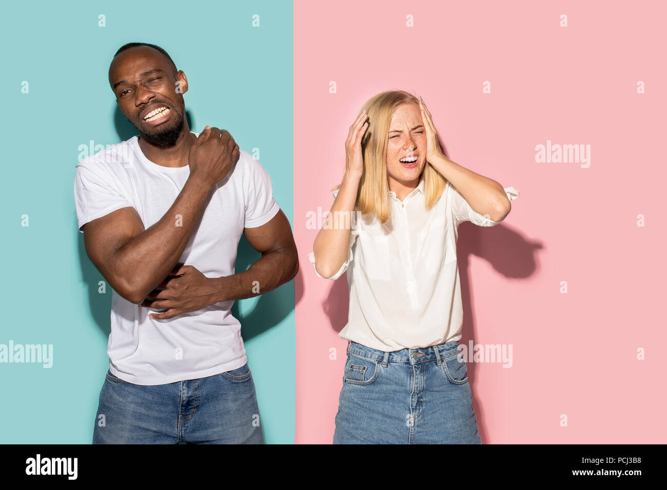 Young couple with a pain in the shoulder Stock Photo - Alamy