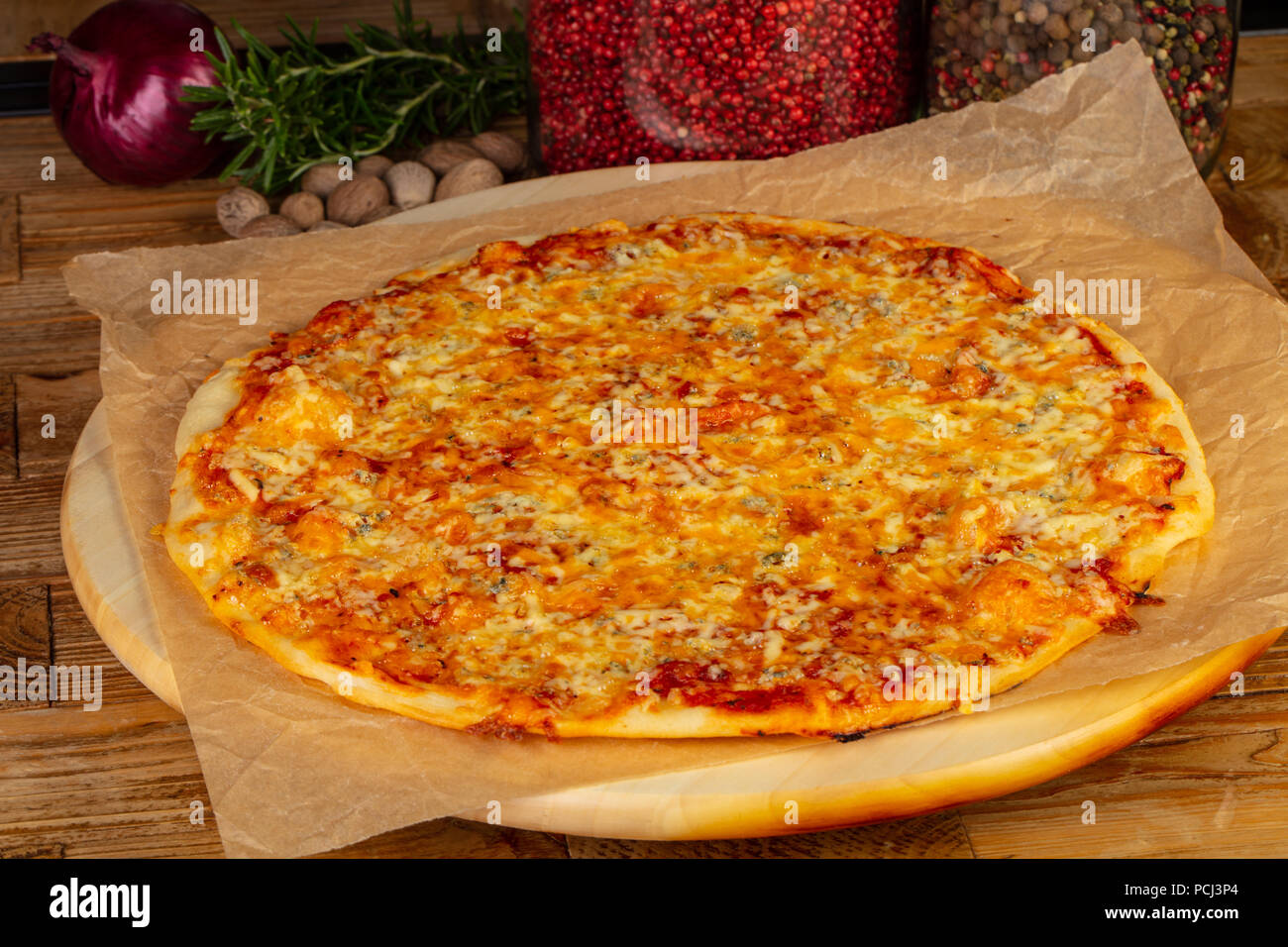 Delicious and big "4 cheese" pizza Stock Photo - Alamy