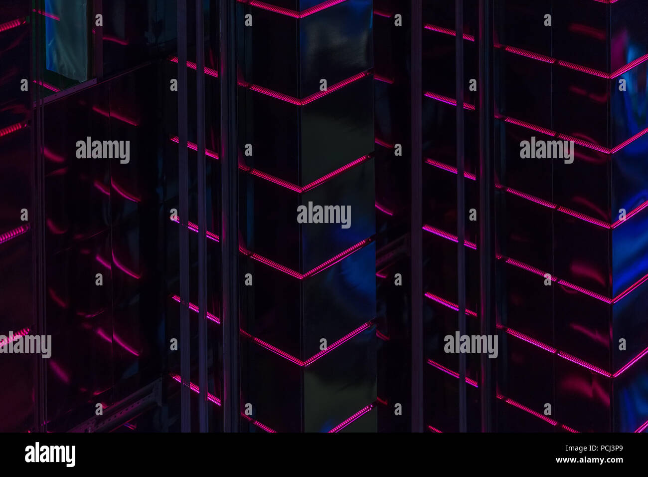 Abstract wall of modern high lighting of skyscraper, bright vivid led ...