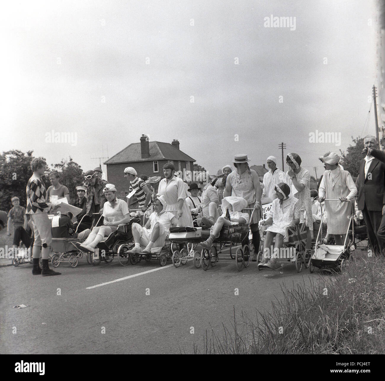 1960s, historical, English village pram race, competitors in costumes ...