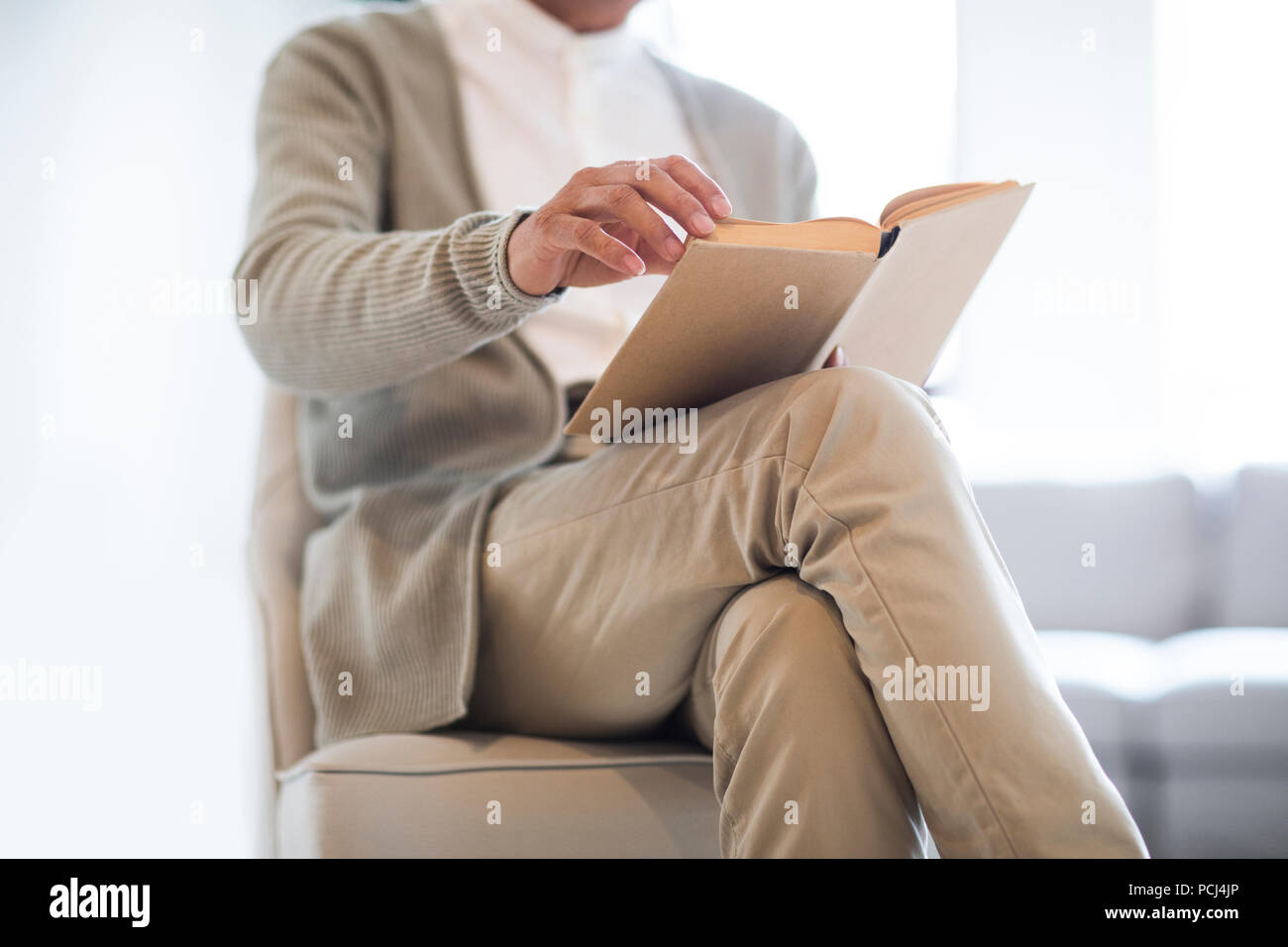 Senior Chinese man reading a book at home Stock Photo - Alamy