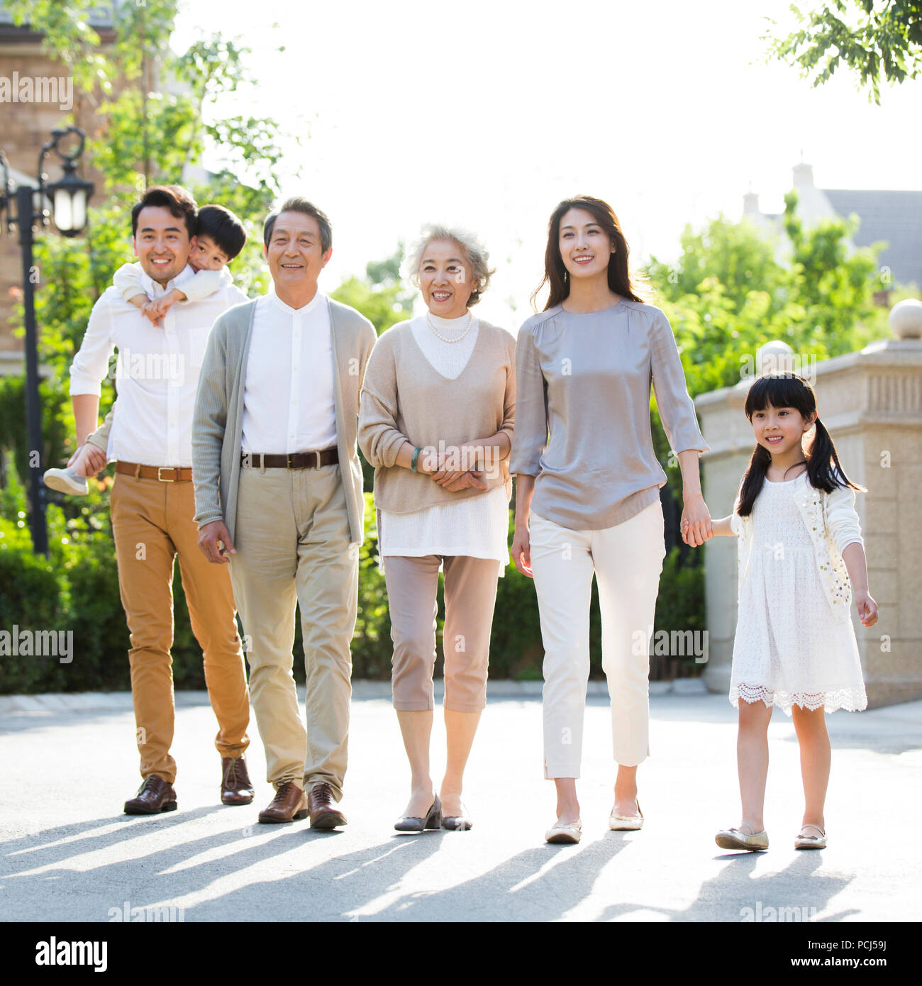 Happy Chinese family strolling outside Stock Photo - Alamy