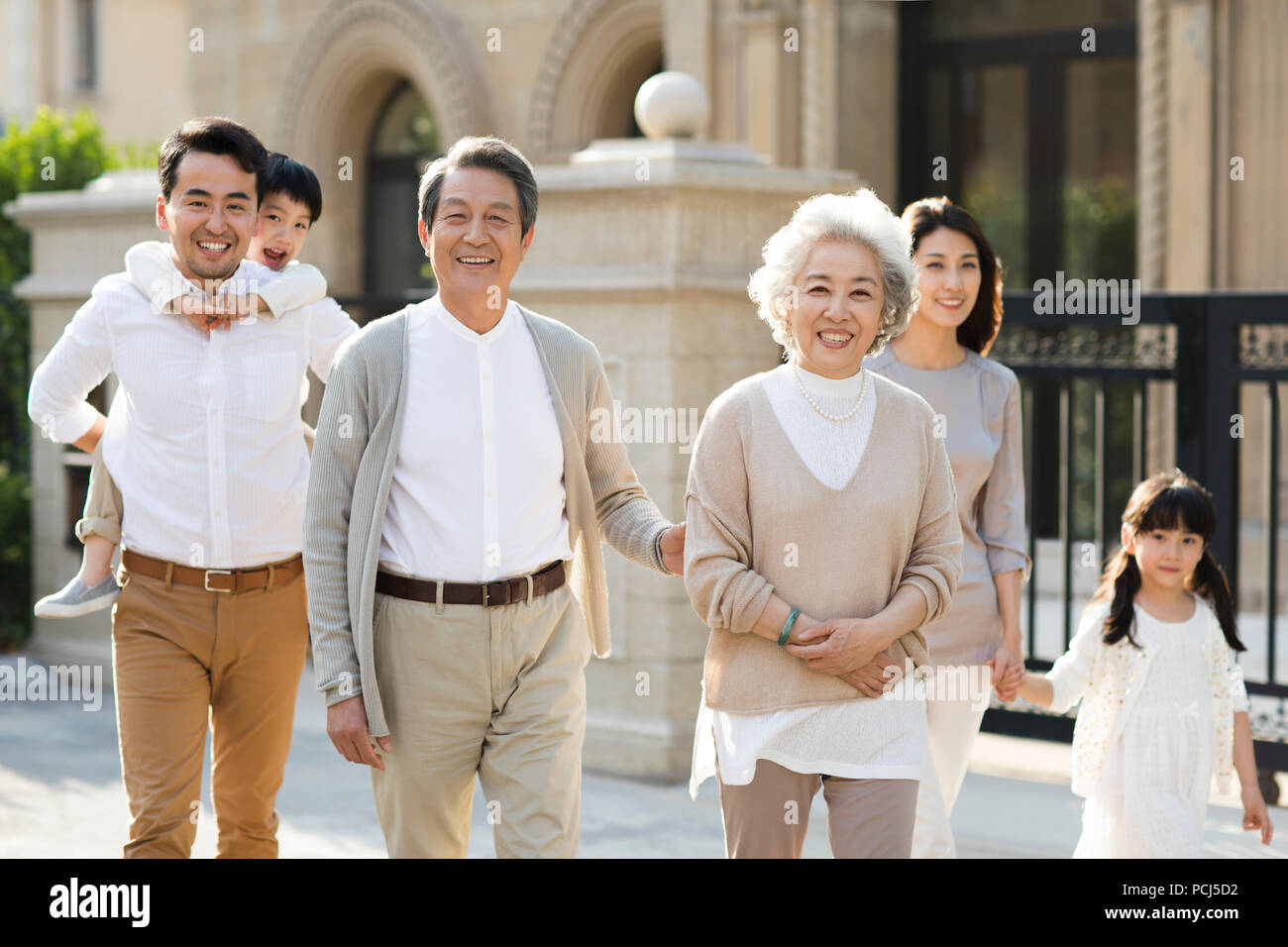 Happy Chinese family strolling outside Stock Photo - Alamy