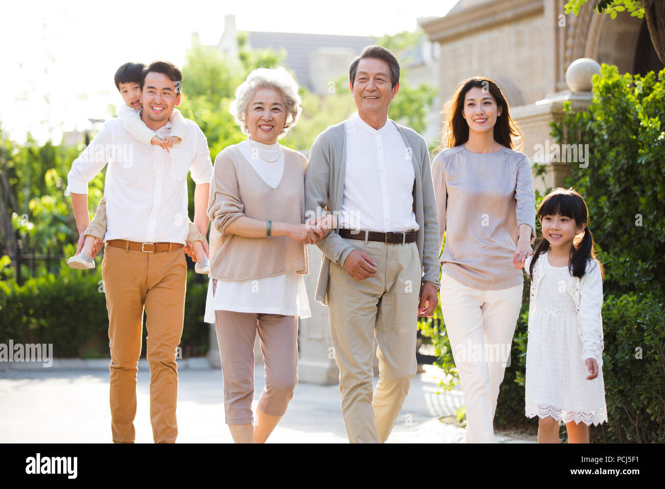 Happy Chinese family strolling outside Stock Photo - Alamy