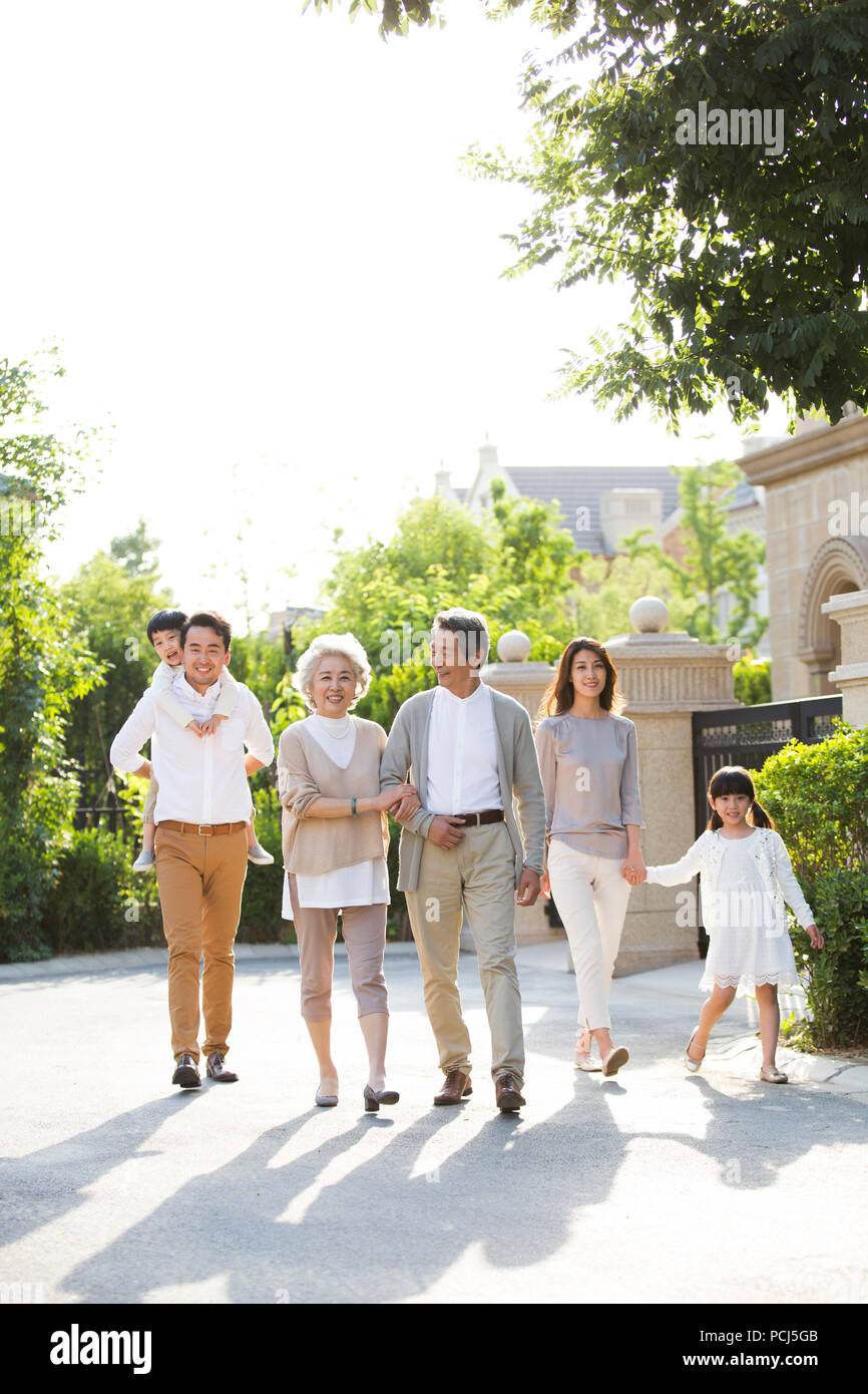 Happy Chinese family strolling outside Stock Photo - Alamy