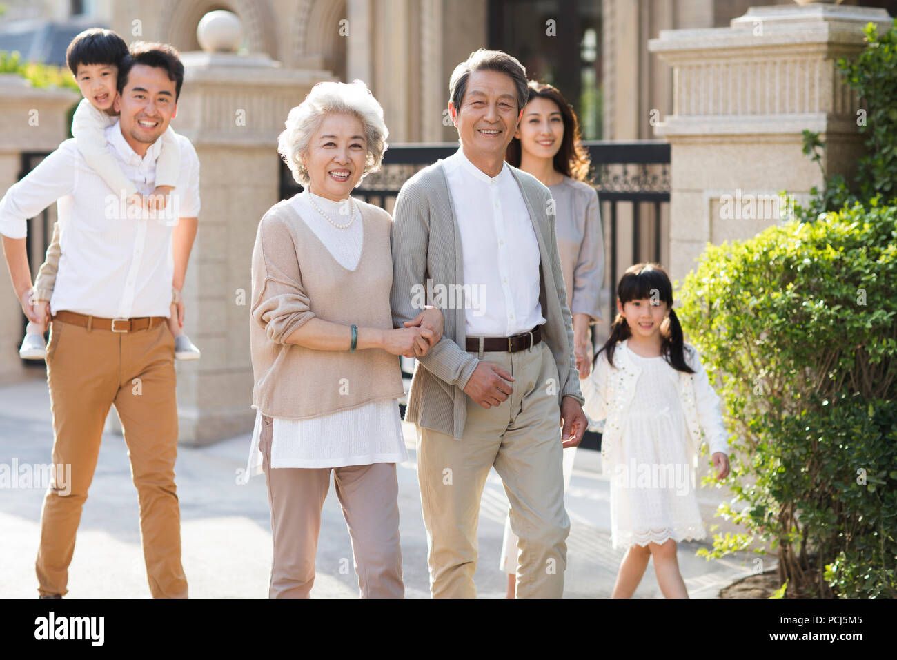 Happy Chinese family strolling outside Stock Photo - Alamy